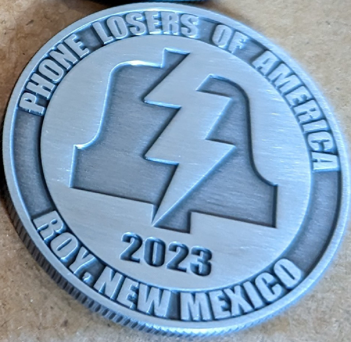 1 PLA Coin from 2023 | Phone Losers of America